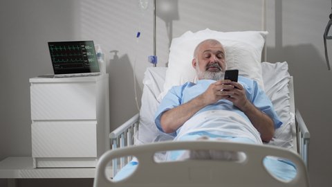 Male Patient Using Mobile Phone Ward Stock Footage Video (100% Royalty ...