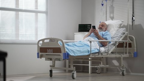 Male Patient Using Mobile Phone Ward Stock Footage Video (100% Royalty ...