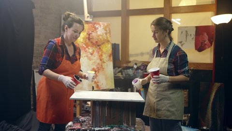 Women Artists Throwing Acrylic Paint On Stock Footage Video (100% ...