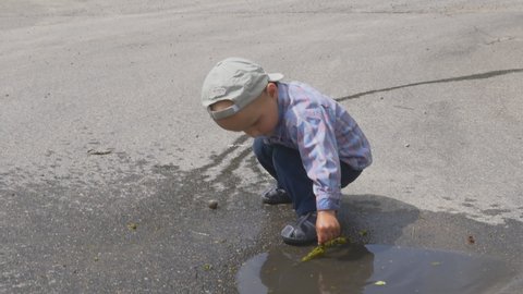 Cute Little Boy Playing Stick Puddle Stock Footage Video (100% Royalty ...