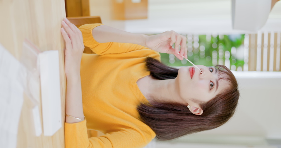 4K Asian woman using rapid antigen test kit for self test COVID-19 ...