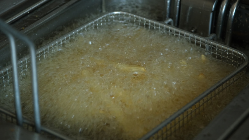 Fried potato chips rotating on white background in 4K with free place ...