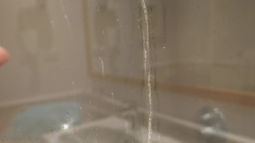 misted glass shower woman's hand wipes Stock Footage Video (100% ...