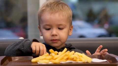 Cute Kid Eating French Fries Fast Stock Footage Video (100% Royalty ...