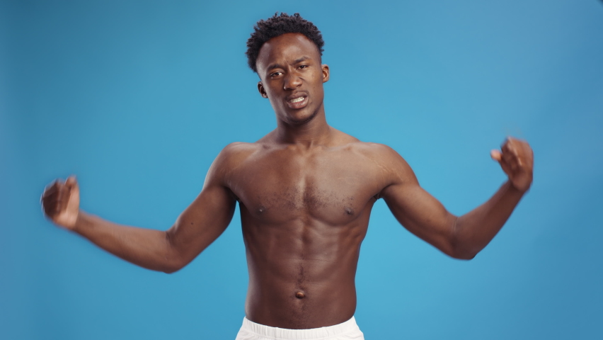 Primal instinct. Angry muscular man screaming at camera and breaking ...