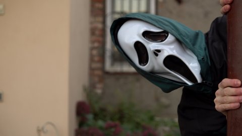 Man Screaming Mask Appears Around Corner Stock Footage Video (100% ...