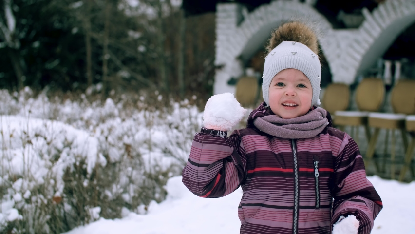 lttle girl playing snowballs throwing snow Stock Footage Video (100% ...