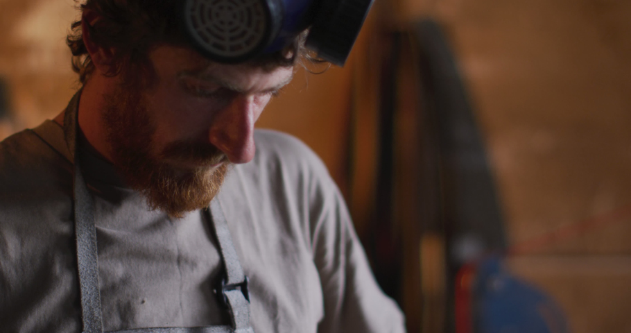 caucasian male blacksmith wearing breathing mask Stock Footage Video ...