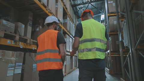 Two People Walking Through Warehouse Two Stock Footage Video (100% ...