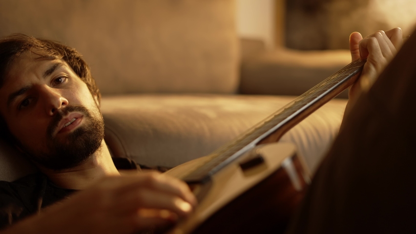 sad man playing on guitar while Stock Footage Video (100% Royalty-free ...