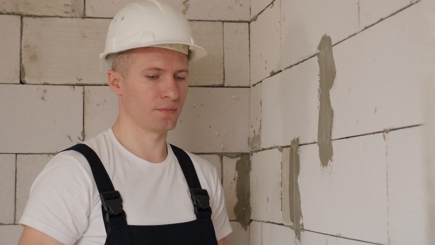 construction worker using spirit level marking Stock Footage Video (100 ...