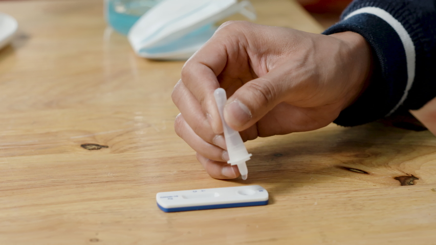 4K Asian woman using rapid antigen test kit for self test COVID-19 ...