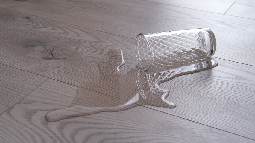 glass water spilled on laminate floor Stock Footage Video (100% Royalty ...