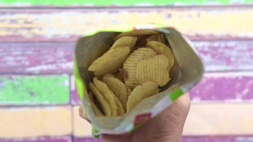 holding open potato chips packet top Stock Footage Video (100% Royalty ...