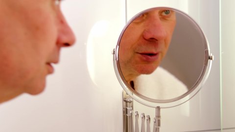 Old man looking into mirror Stock Video Footage - 4K and HD Video Clips ...