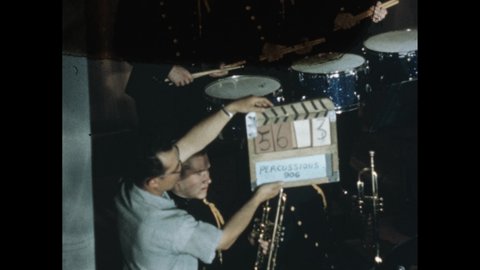 1950s Man Holding Clapperboard Clapping Drummers Stock Footage Video ...