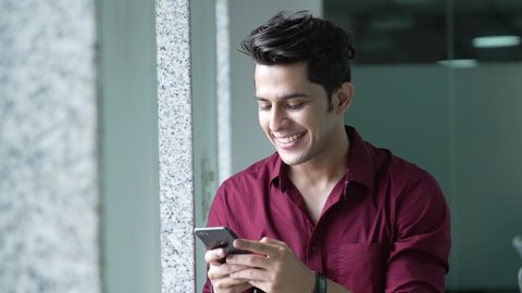 Smiling Indian Young Man Using Mobile Stock Footage Video (100% Royalty ...