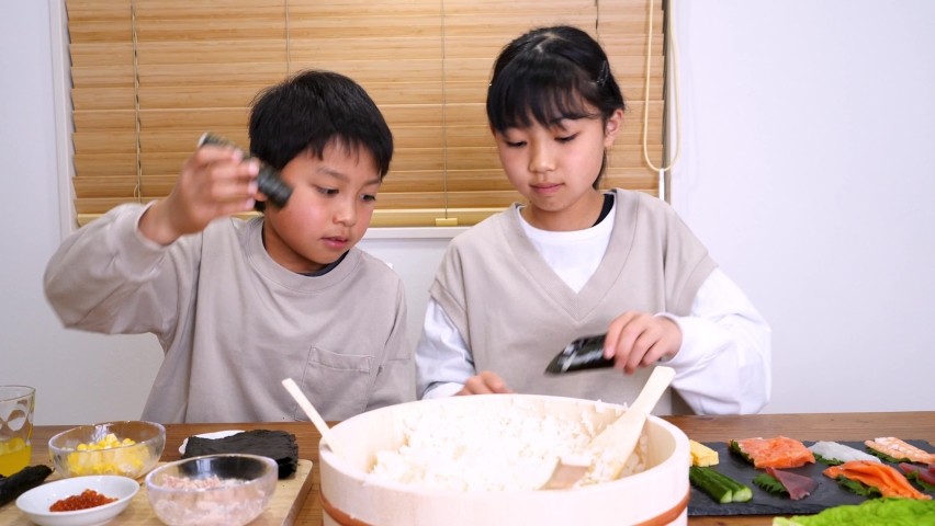 asian kids eating hand-rolled sushi home Stock Footage Video (100% ...