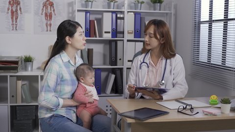 Pretty Asian Pediatrician Answering Questions Patiently Stock Footage ...