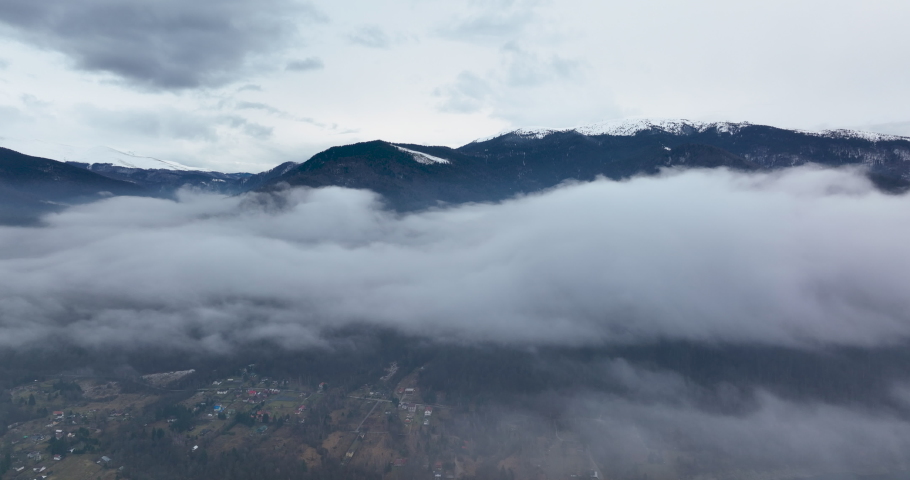 Flying Backward Through Clouds Between Snowcapped Stock Footage Video ...