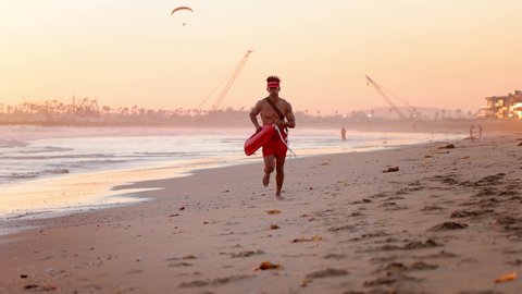African American Lifeguard Running Along Beach Stock Footage Video (100 ...