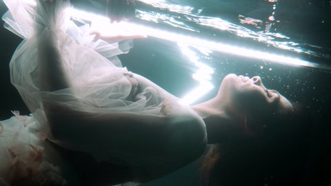 Fascinating Lady Floating Underwater Magic Light Stock Footage Video ...