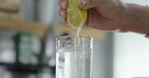 Squeezing Lemon Into Glass Water Stock Footage Video (100% Royalty-free) 1093387971 | Shutterstock