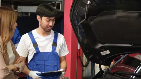 Car Mechanic Explaining Female Customer Problem Stock Footage Video ...