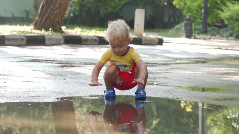 Happy Child Having Fun Playing Puddle Stock Footage Video (100% Royalty ...