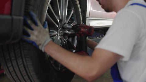 Auto Mechanic Putting Wheels On Car Stock Footage Video (100% Royalty ...