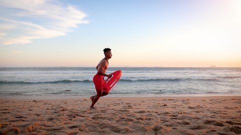 African American Lifeguard Running Along Beach Stock Footage Video (100 ...