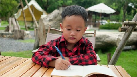 Asian Boy Writing Book Online Learning Stock Footage Video (100% ...