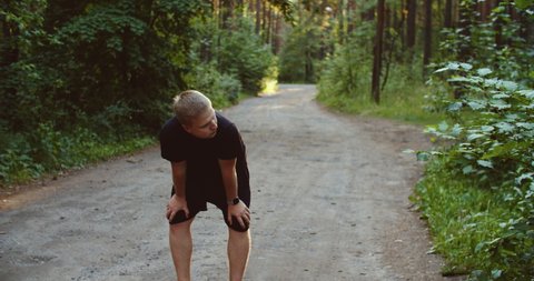 Tired Male Runner Finishes His Run Stock Footage Video (100% Royalty ...
