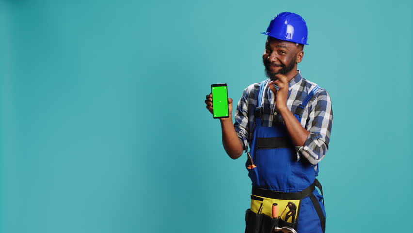 Young builder walking with a toolbox, rushing being late on a Green ...