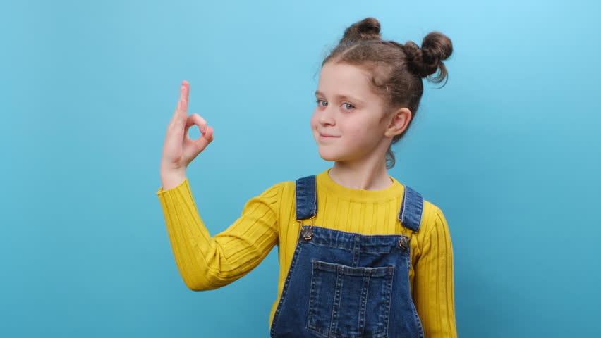 Like. Happy young preteen child girl kid looking approvingly at camera showing thumbs up, like ...