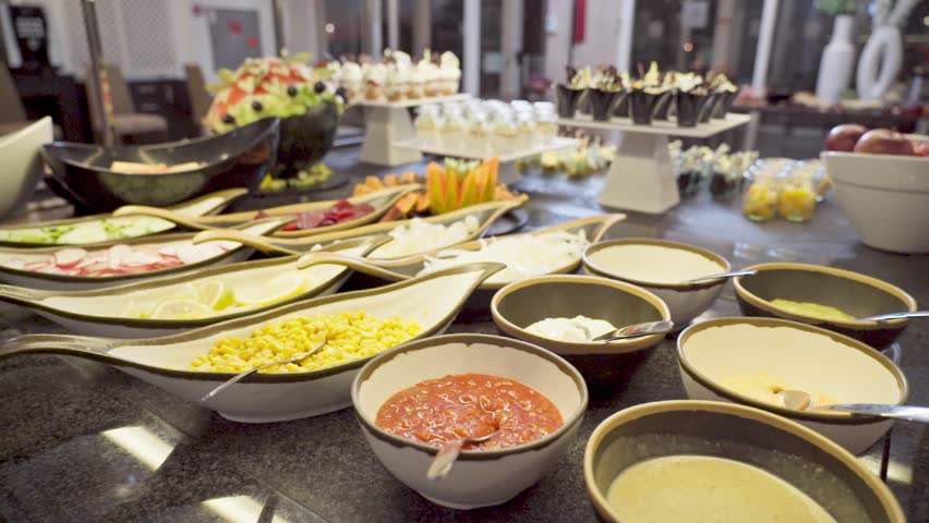 Delicious panoramic view of the buffet table with waffle and donut in a ...
