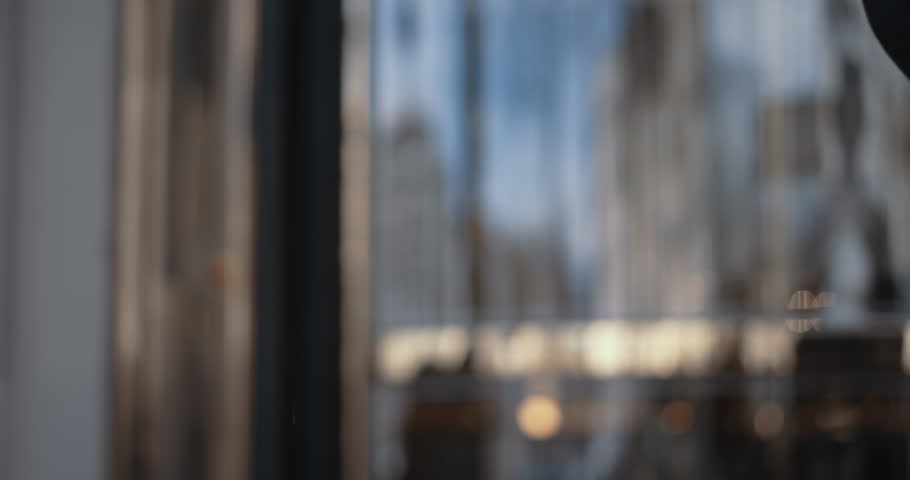 Lobby greeter standing in front of revolving doors and entrance to the ...