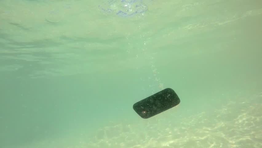 Smartphone Sinking in Sea Water. Stock Footage Video (100% Royalty-free ...