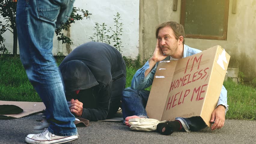 royalty-free-tired-hobo-man-on-the-street-sign-on-cardboard