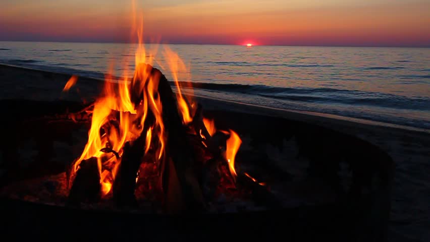 campfire burns brightly sunset along beautiful Stock Footage Video (100 ...