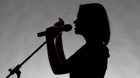 backlit silhouette singer vocalist girl standing Stock Footage Video ...