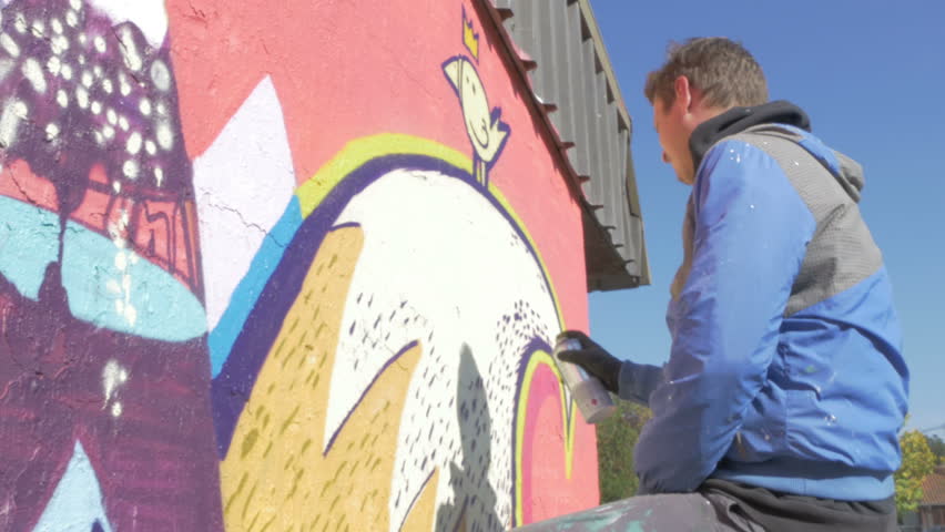 graffiti artist standing on ladder spraying Stock Footage Video (100% ...