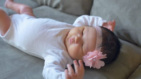 Wiggling Newborn Baby Laying On Couch Stock Footage Video (100% Royalty ...