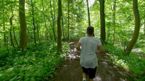 Tracking Shot Man Running Through Trees Stock Footage Video (100% ...