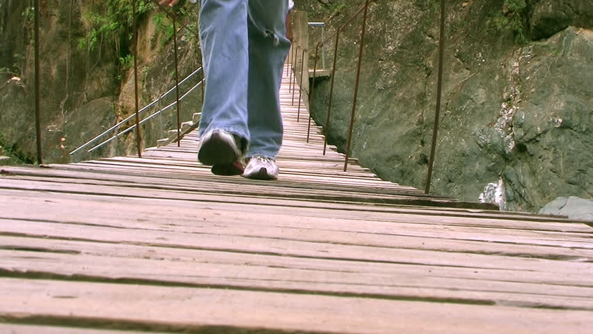 walking across wooden rope bridge Stock Footage Video (100% Royalty ...