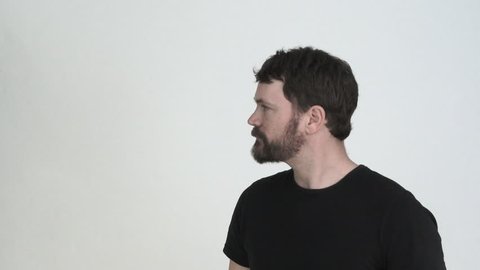 man turning his head against plain Stock Footage Video (100% Royalty ...