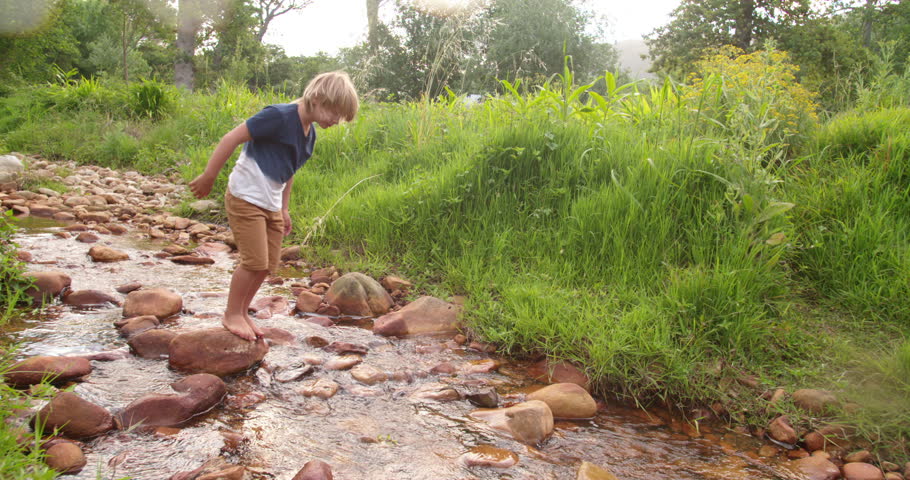 Adventurous Boy Jumping Over Rocks Stock Footage Video (100% Royalty ...