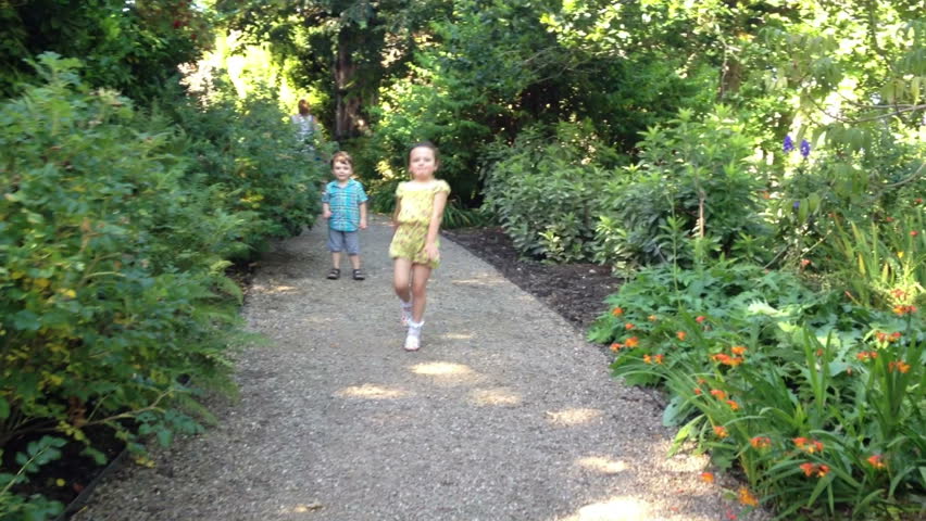 children skipping down garden path Stock Footage Video (100% Royalty ...