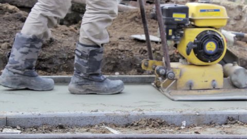 Worker Using Vibrating Machinevibrating Machine Compacting Stock ...