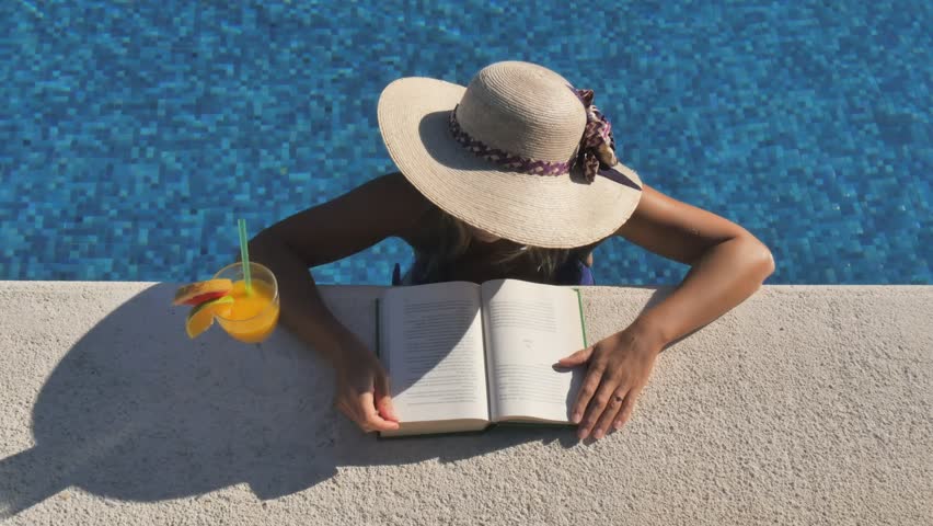 woman relaxing reading book swimming pool Stock Footage Video (100% ...